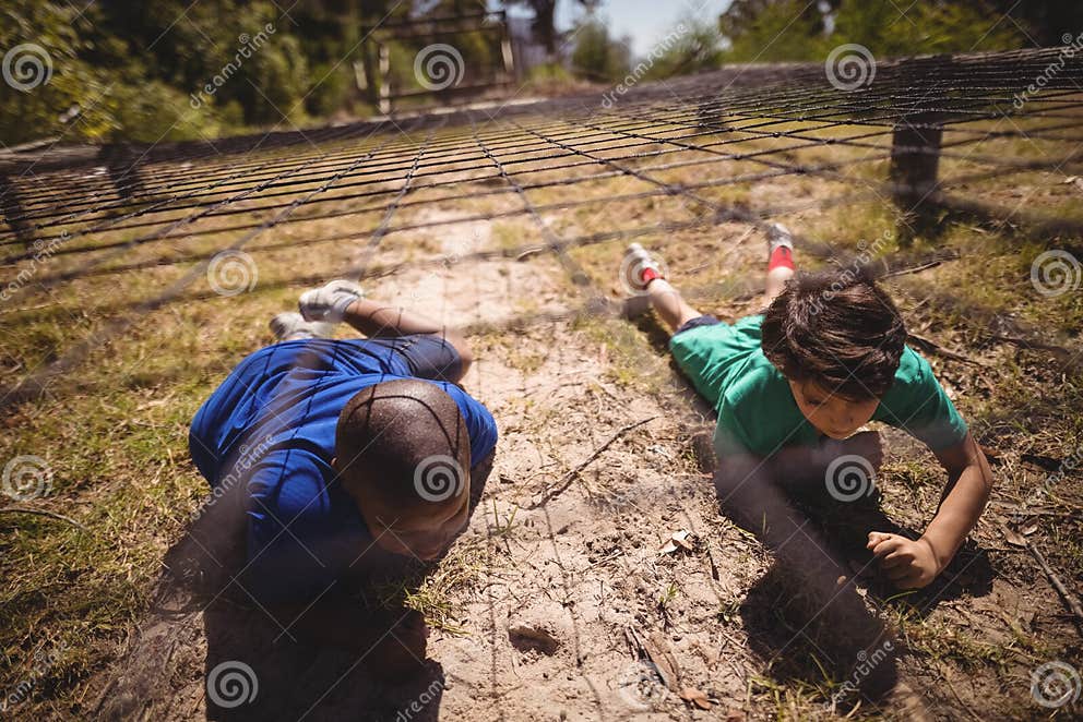Kids Crawling Under the Net during Obstacle Course Stock Image - Image ...