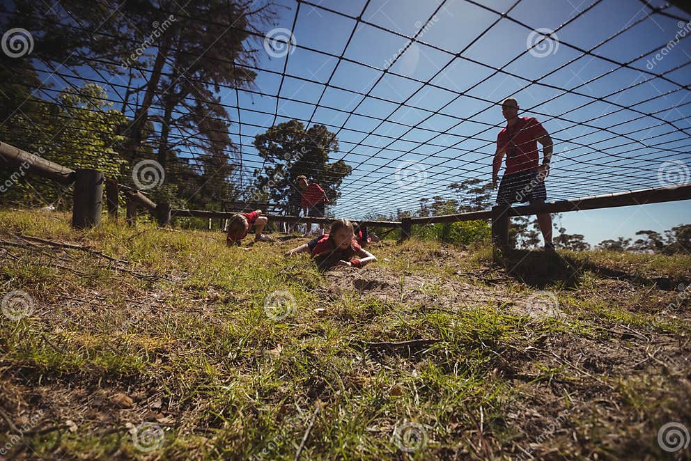 Kids Crawling Under the Net during Obstacle Course Training Stock Image ...