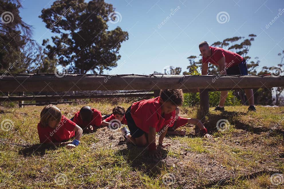 Kids Crawling Under the Net during Obstacle Course Training Stock Photo ...
