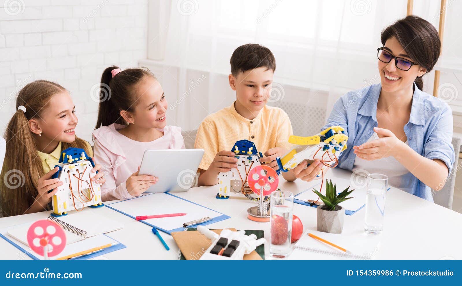 Kids Creating Robots with Teacher in Classroom Stock Photo - Image of ...