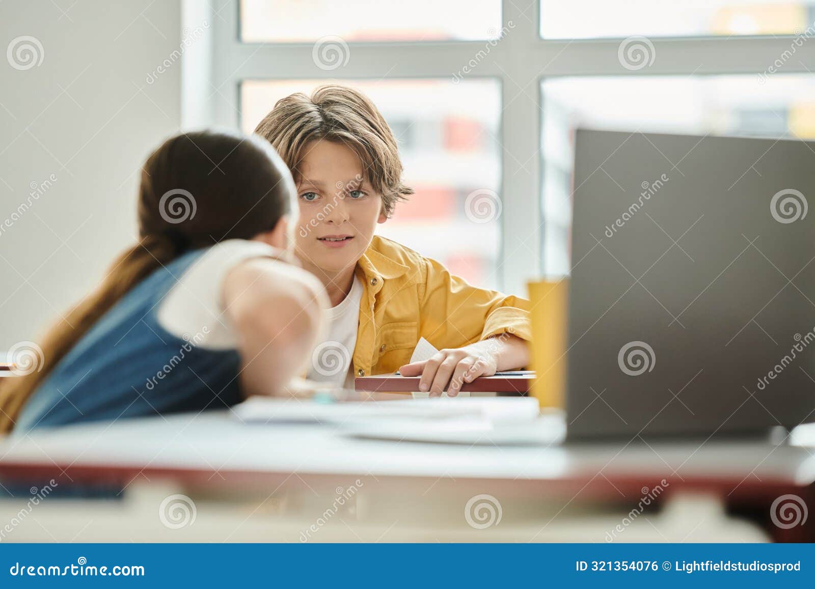 Kids at a desk in front stock photo. Image of classroom - 321354076
