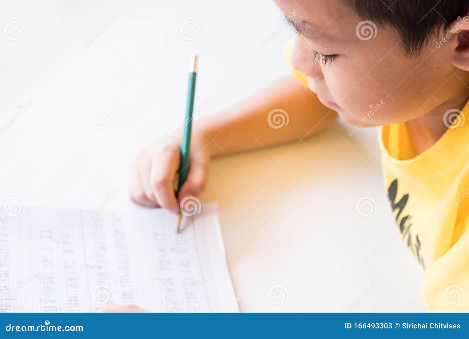 Kids Doing Homework Writing in Their Notebook at Home. a Boy is 8 Years ...