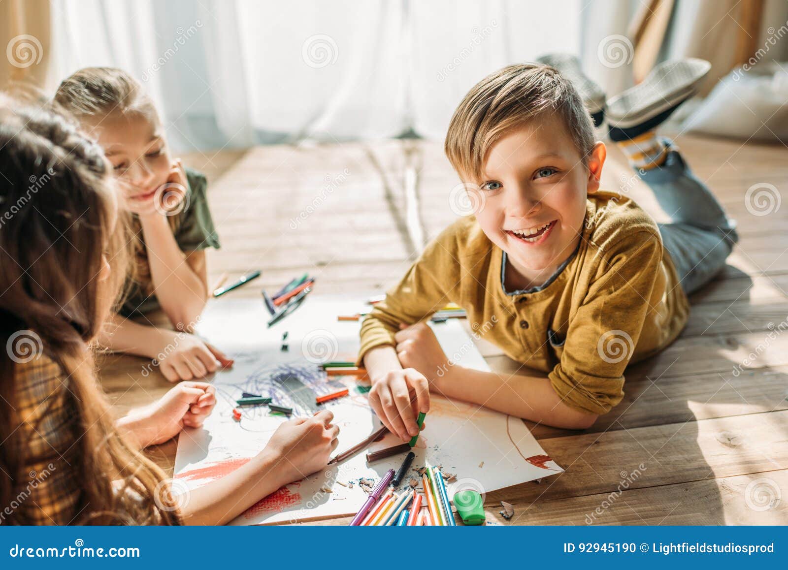 Kids Drawing on Paper with Pencils while Lying on Floor Stock Photo ...
