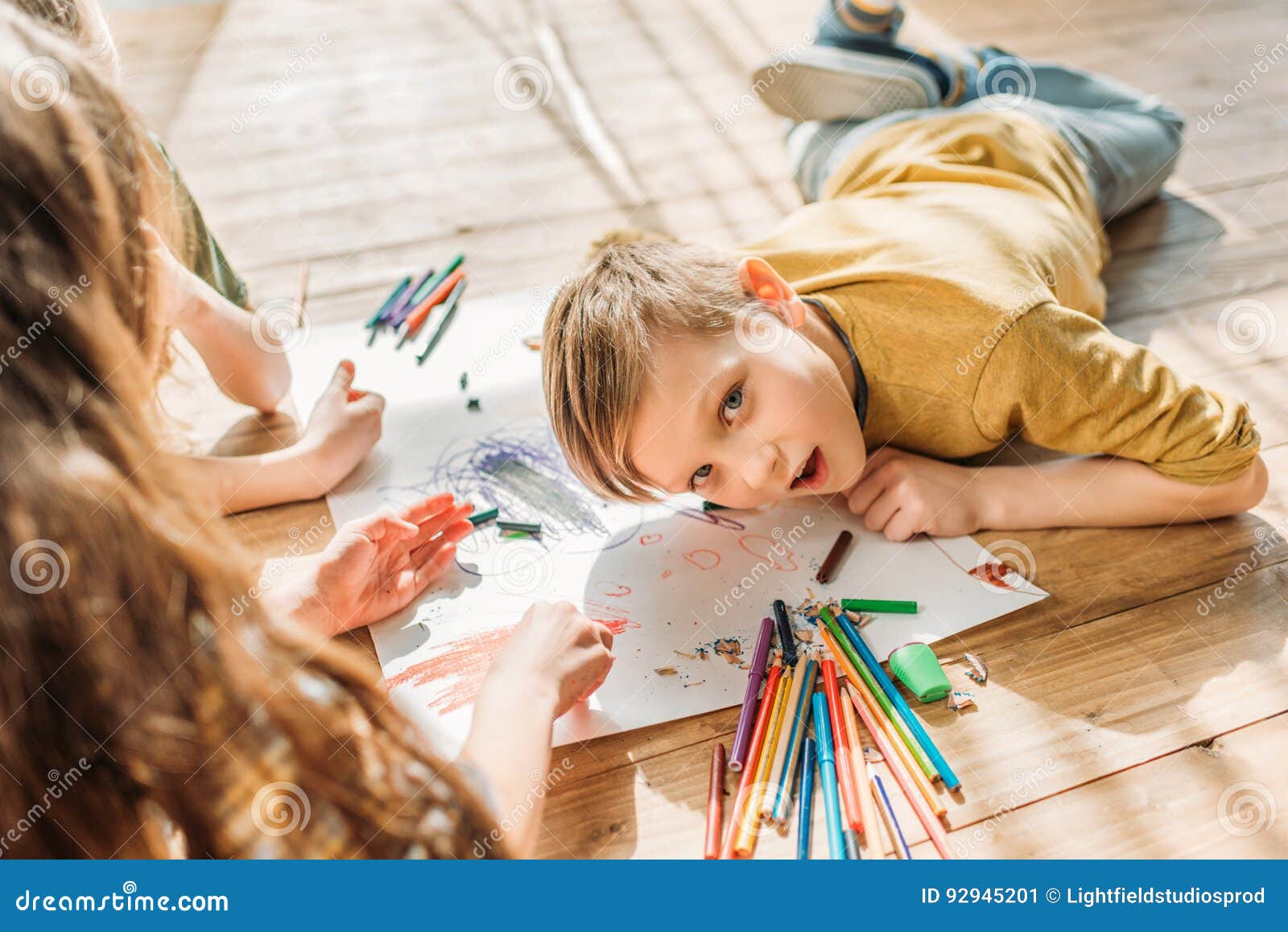 Kids Drawing on Paper with Pencils while Lying on Floor Stock Image ...