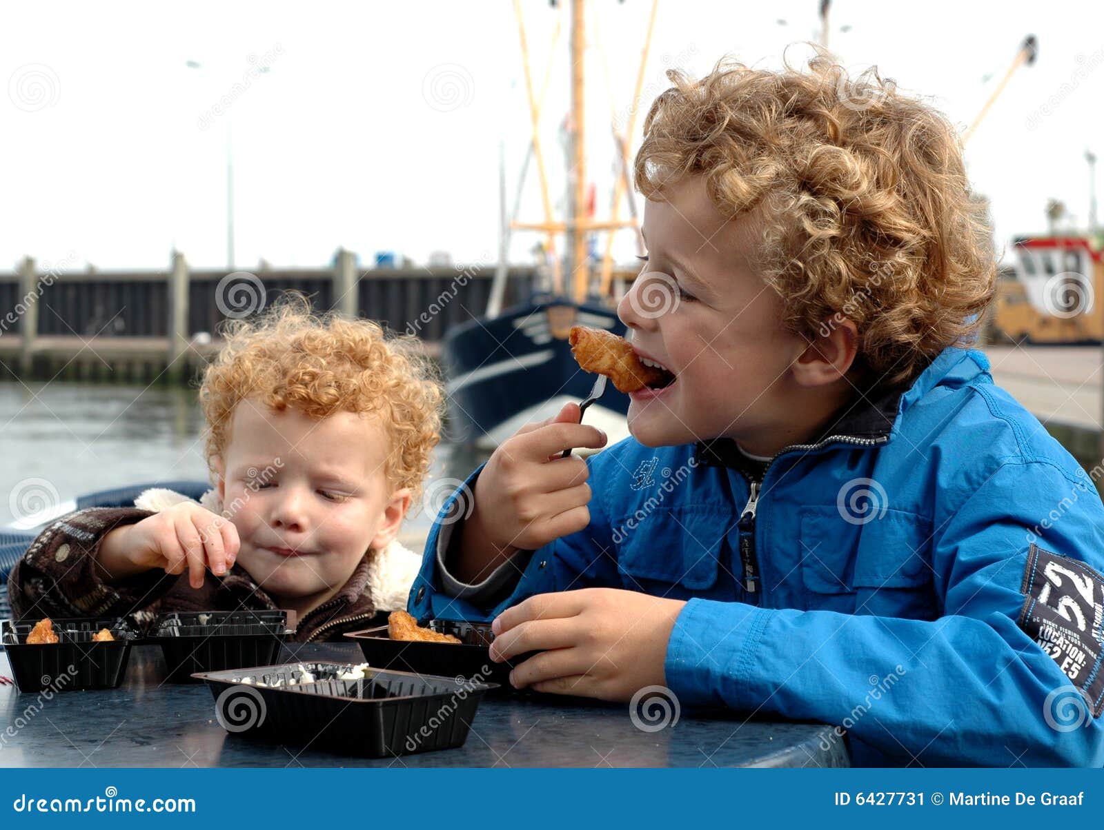Kids eating fish stock image. Image of fishing, sibling - 6427731