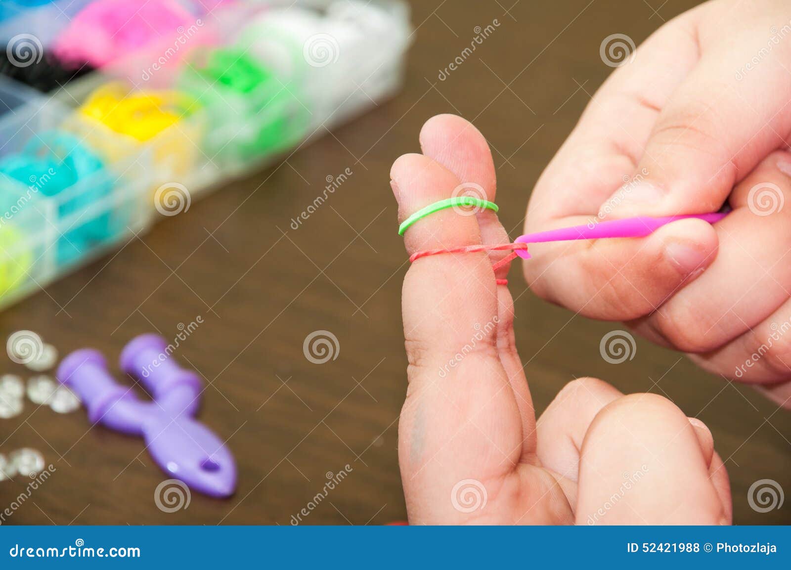 Kids Hands Creating Bracelet with Rubber Bands and Box in the Ba Stock ...