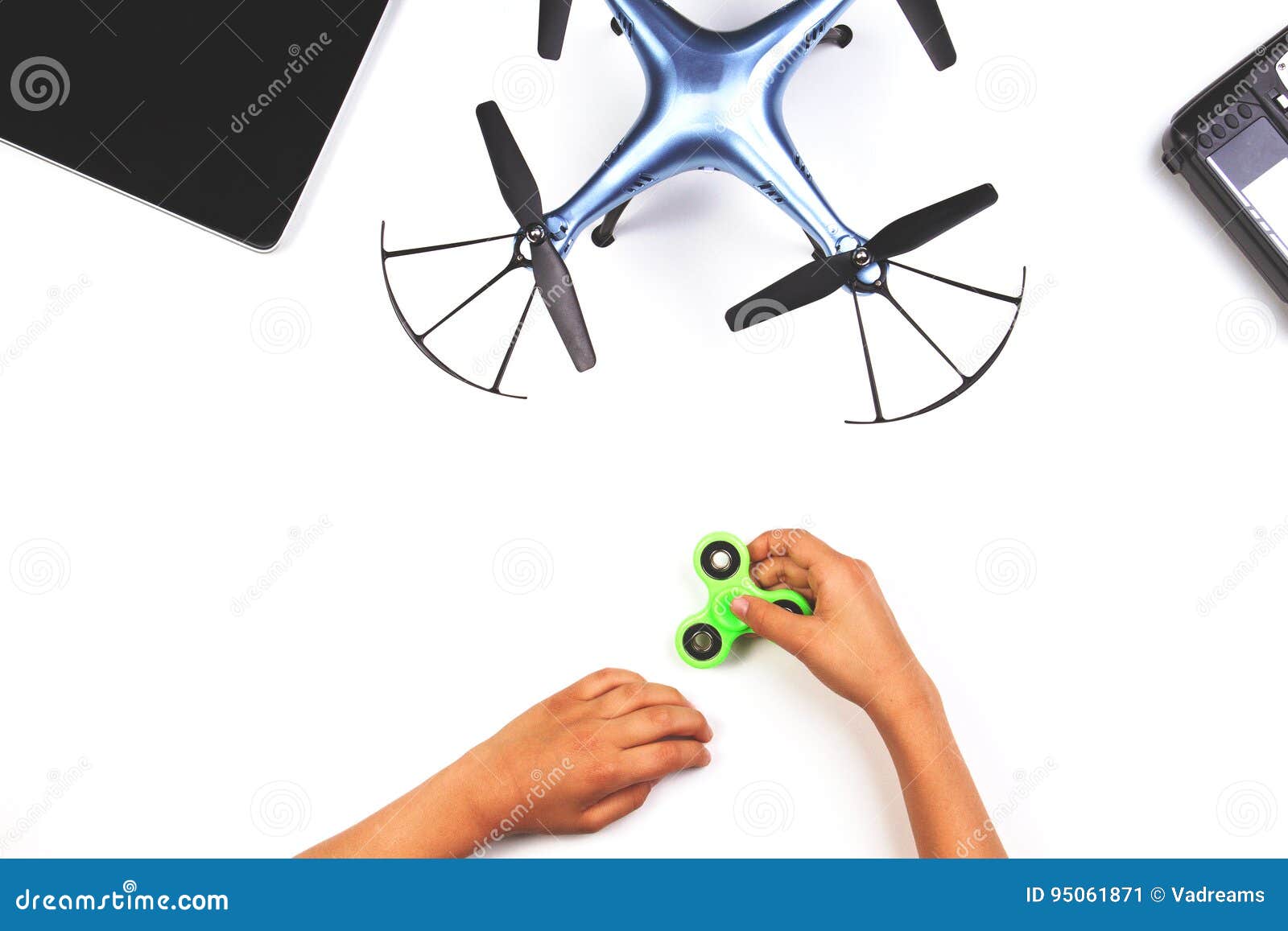 Kids Hands Playing with Fidget Spinner Toy. Drone and Remote Controller ...