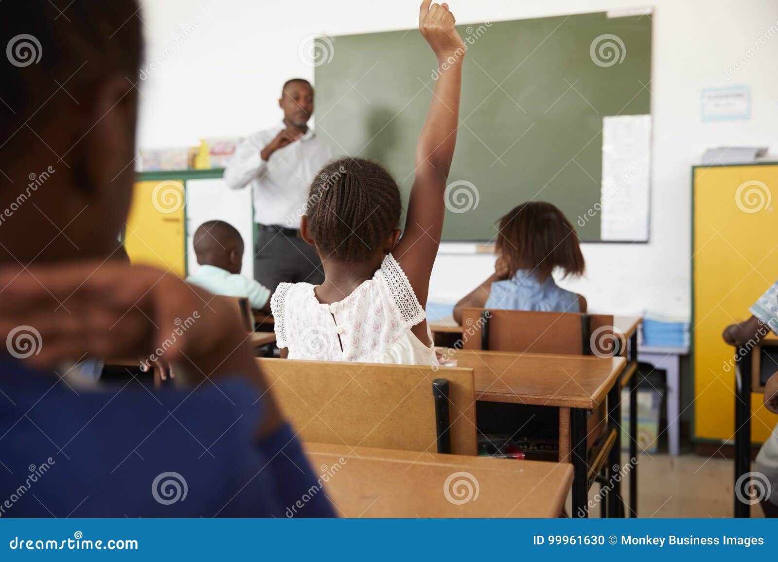 Kids with Hands Up in Elementary School Class, Low Angle Stock Photo ...