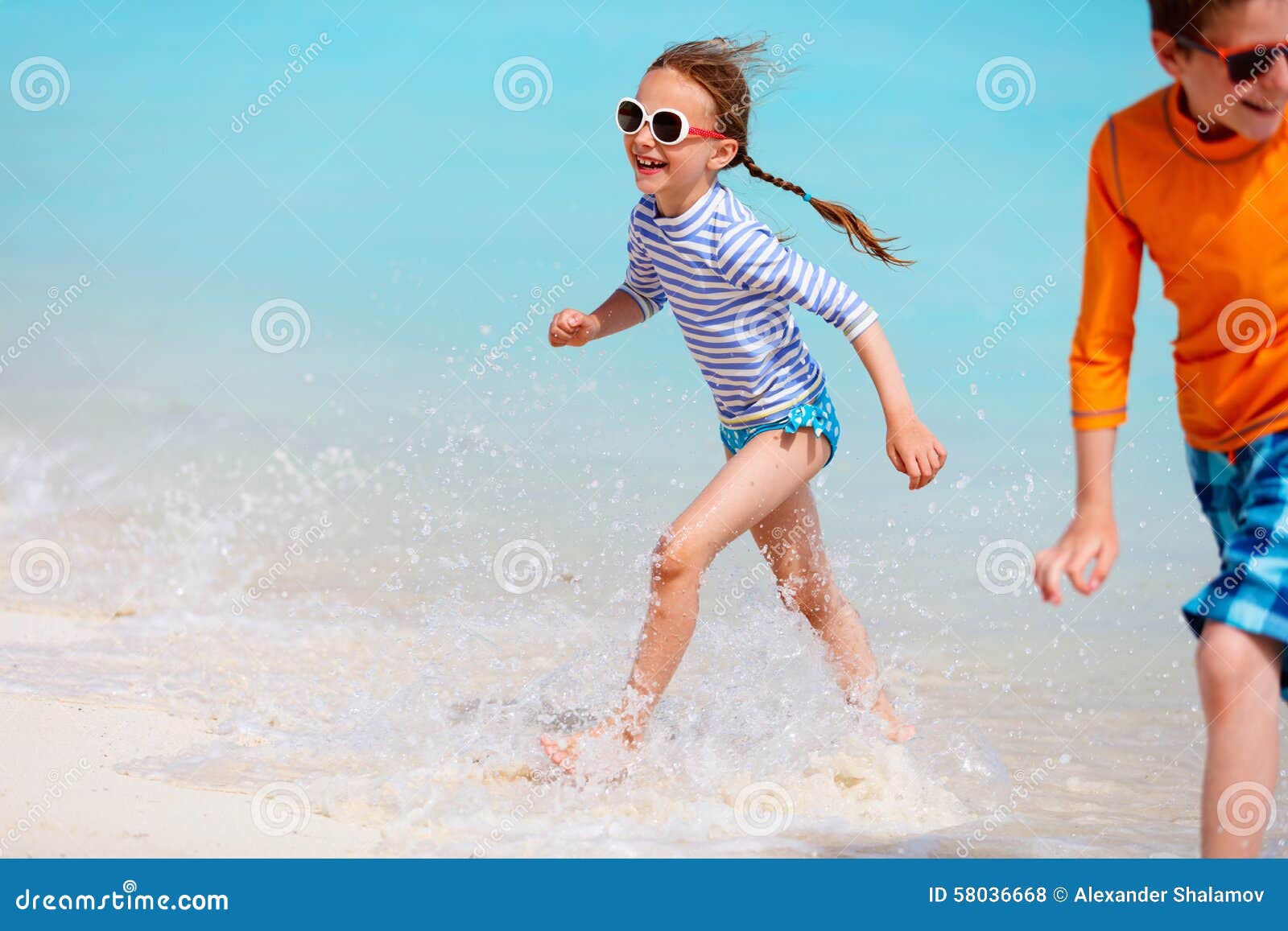 Kids having fun at beach stock photo. Image of coastline - 58036668