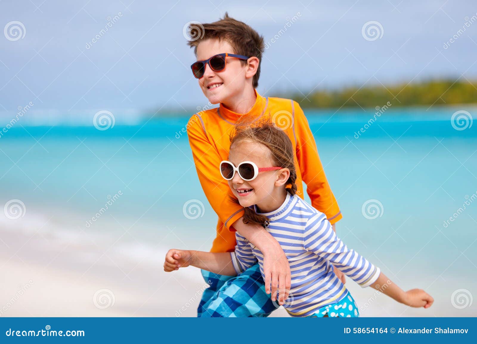 Kids having fun at beach stock photo. Image of action - 58654164