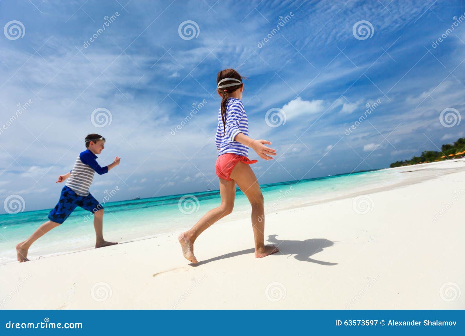 Kids having fun at beach stock image. Image of running - 63573597