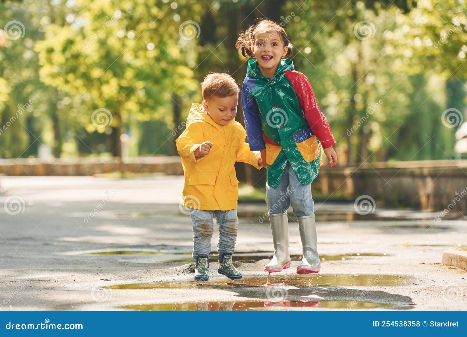 Kids Having Fun Outdoors in the Park after the Rain Stock Photo - Image ...