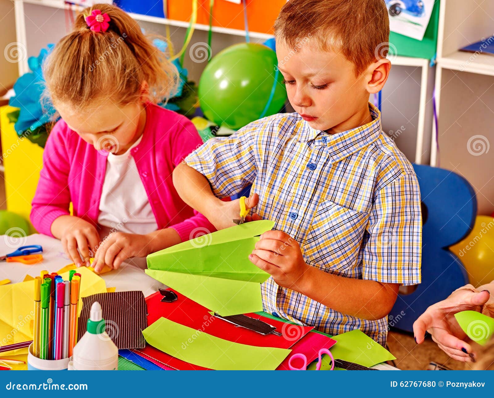 Kids Holding Colored Paper on Table in Stock Photo - Image of male ...