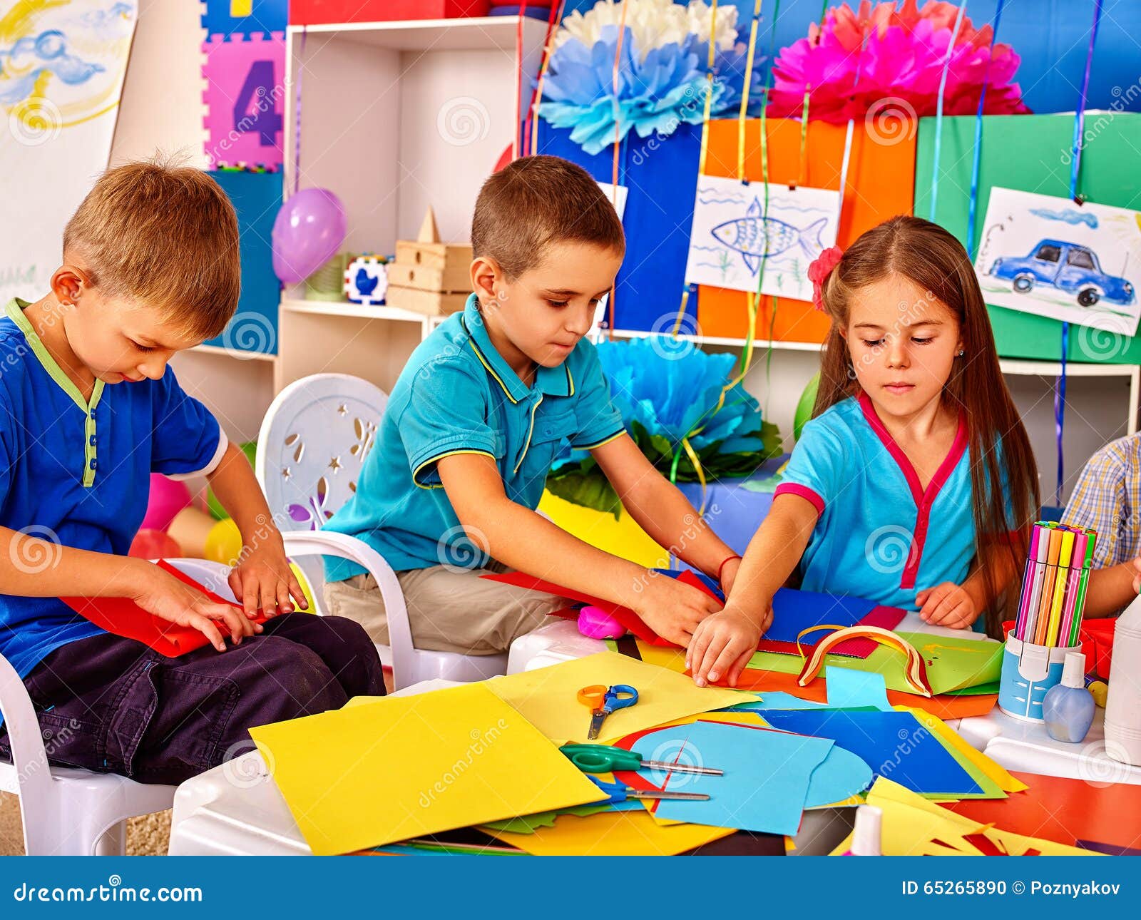 Kids Holding Colored Paper on Table in Stock Photo - Image of lesson ...