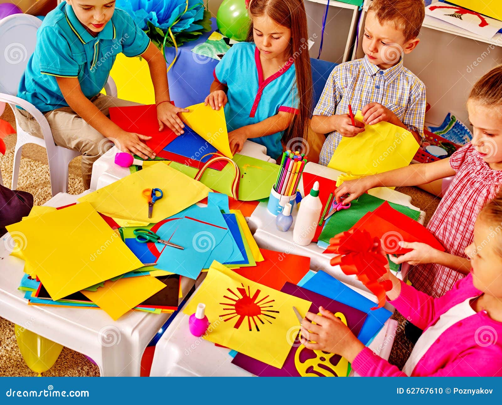 Kids Holding Colored Paper on Table in Stock Photo - Image of crayons ...
