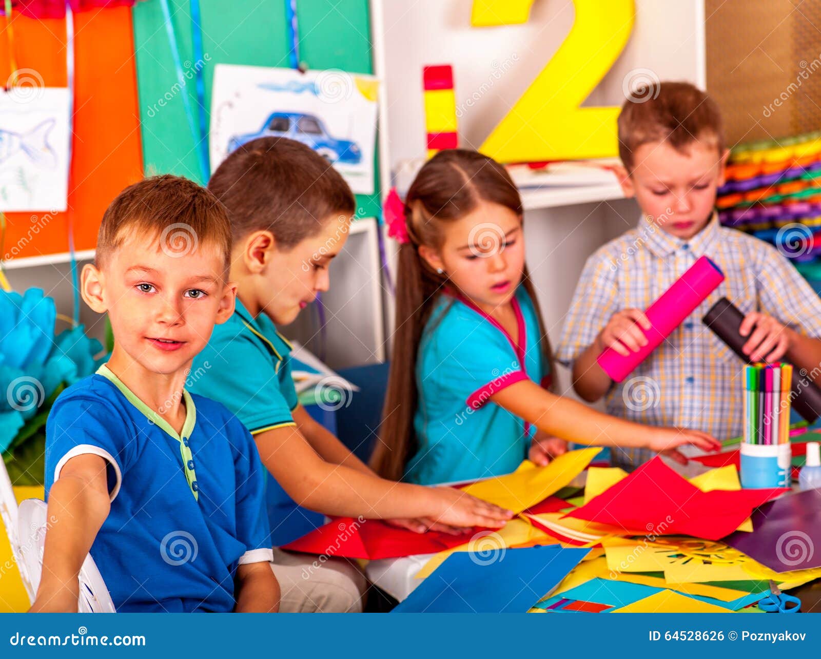 Kids Holding Colored Paper on Table in Stock Photo - Image of lesson ...