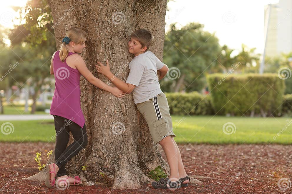 Kids hugging the tree stock image. Image of couple, female - 16760995