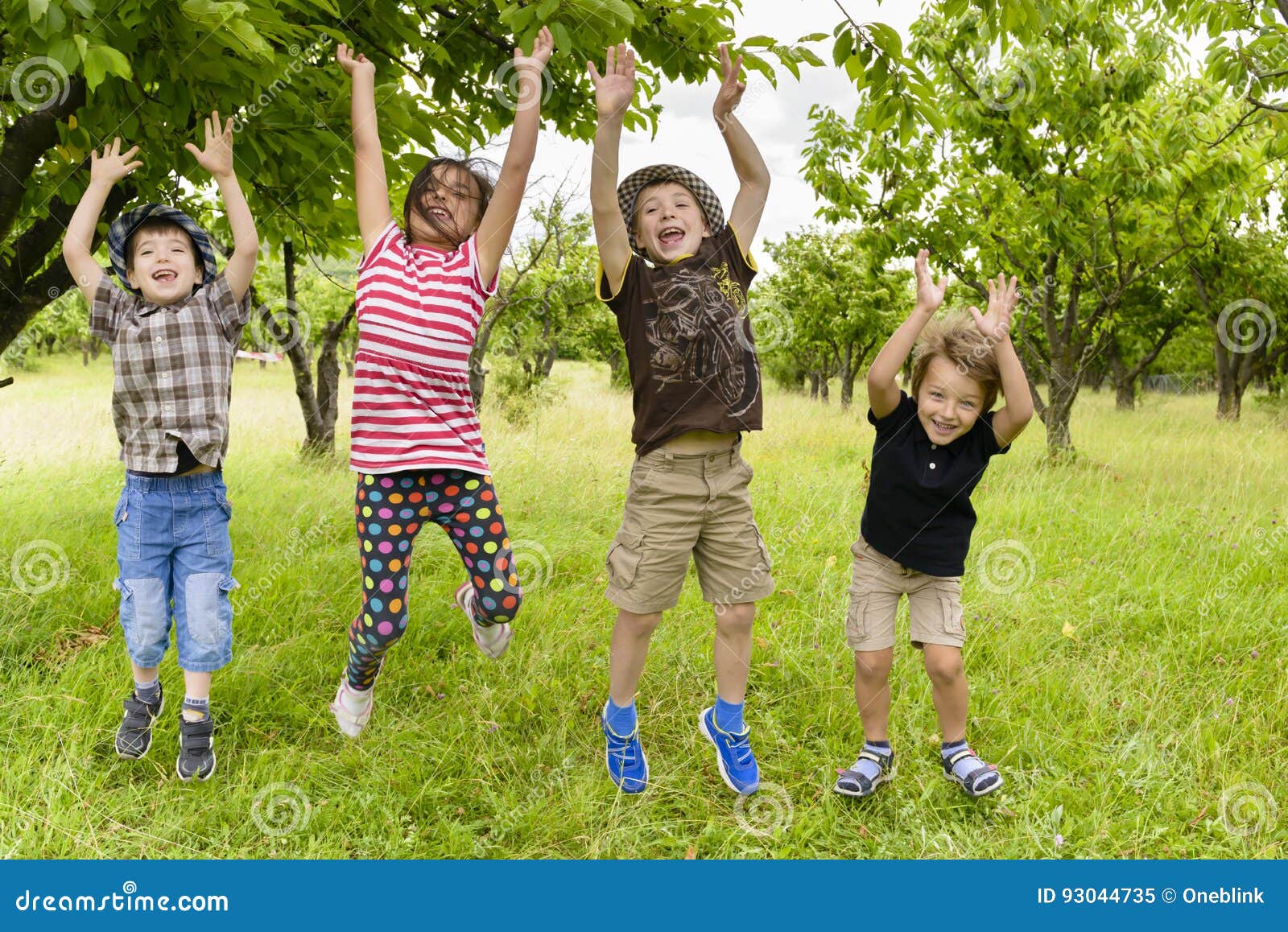 Kids Jumping in a orchard stock image. Image of field - 93044735