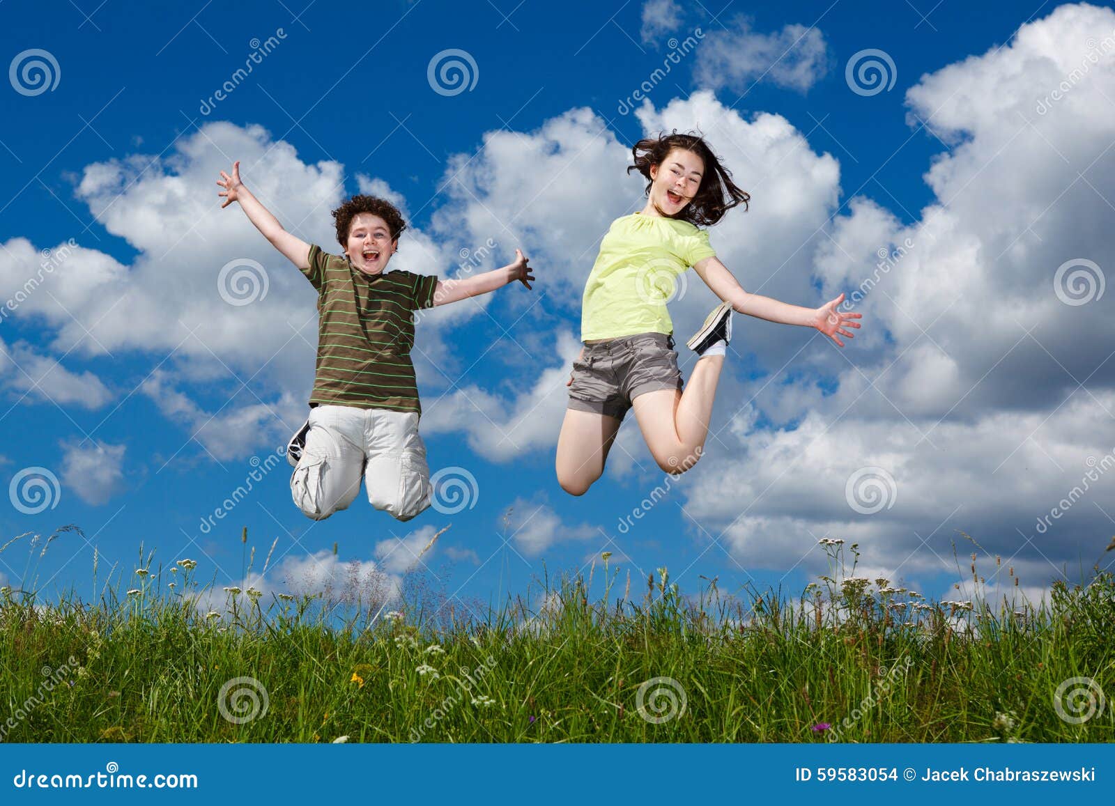 Kids jumping outdoor stock photo. Image of background - 59583054