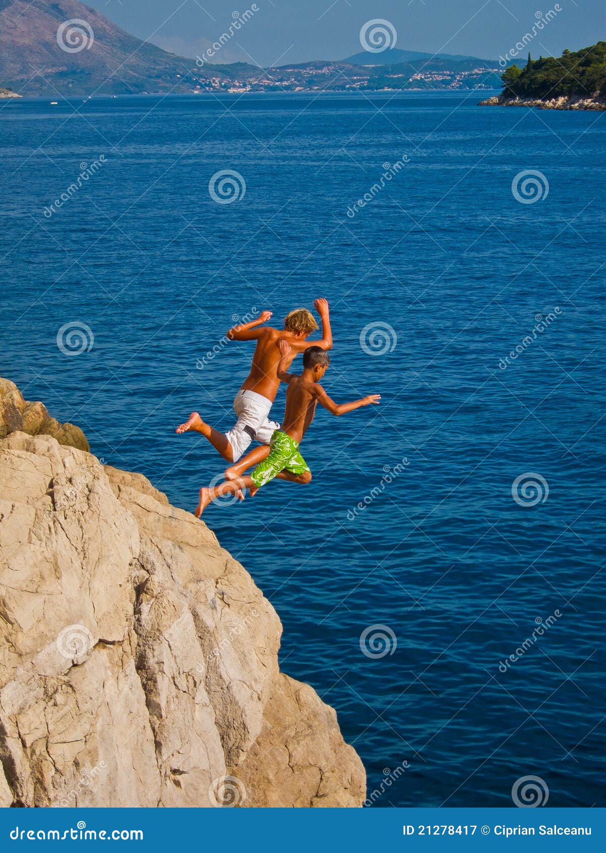 Kids jumping in the water editorial photography. Image of tourism ...