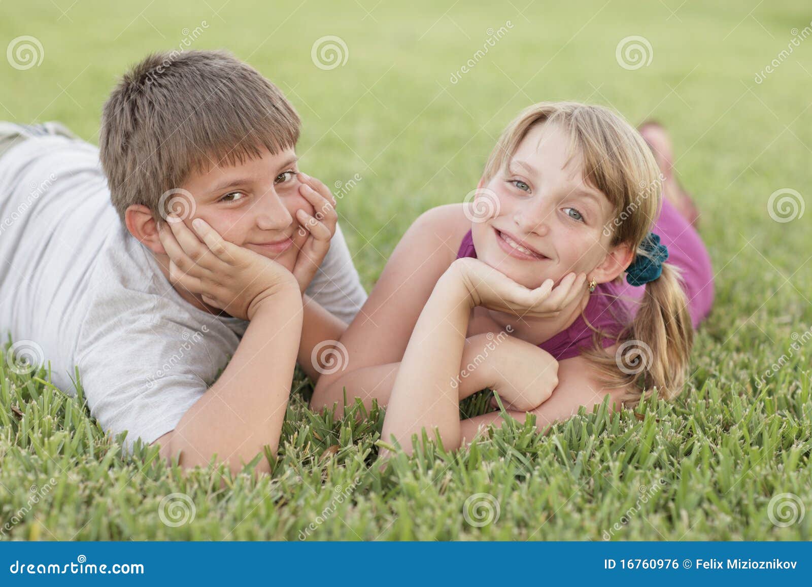 Kids laying on the grass stock photo. Image of wellness - 16760976