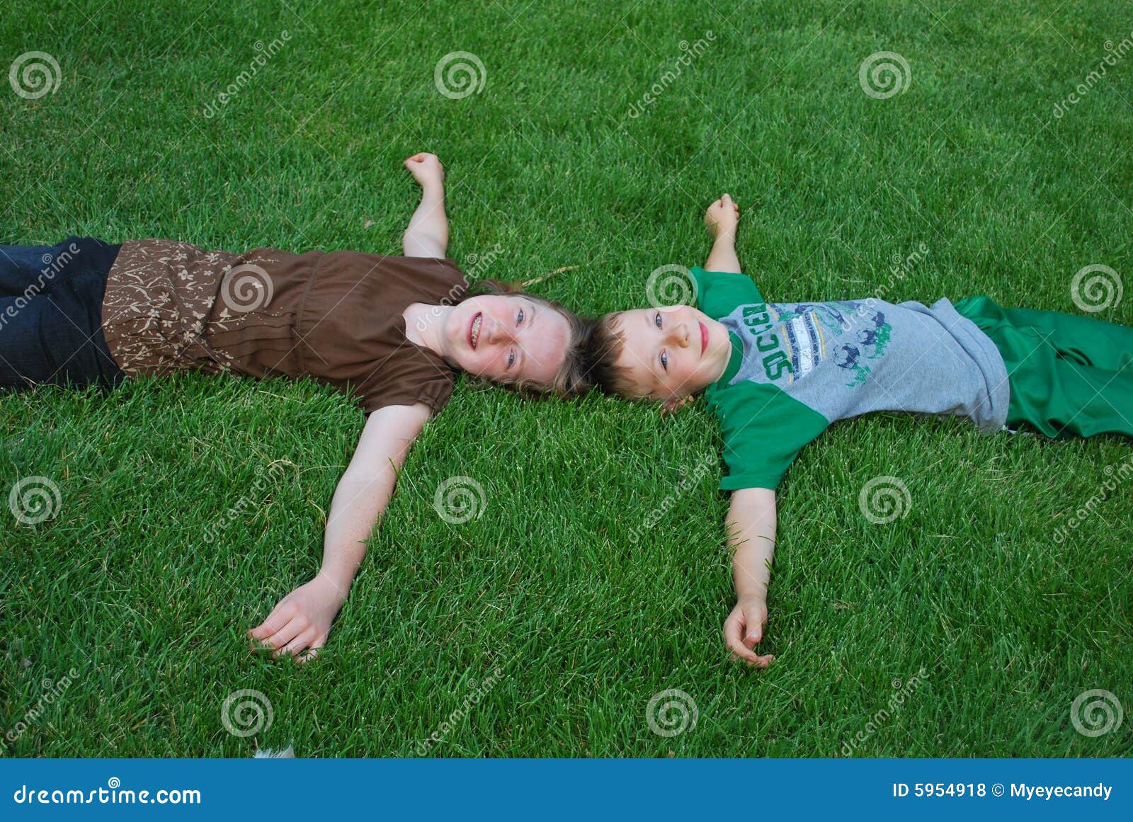 Kids laying on grass stock photo. Image of outside, children - 5954918