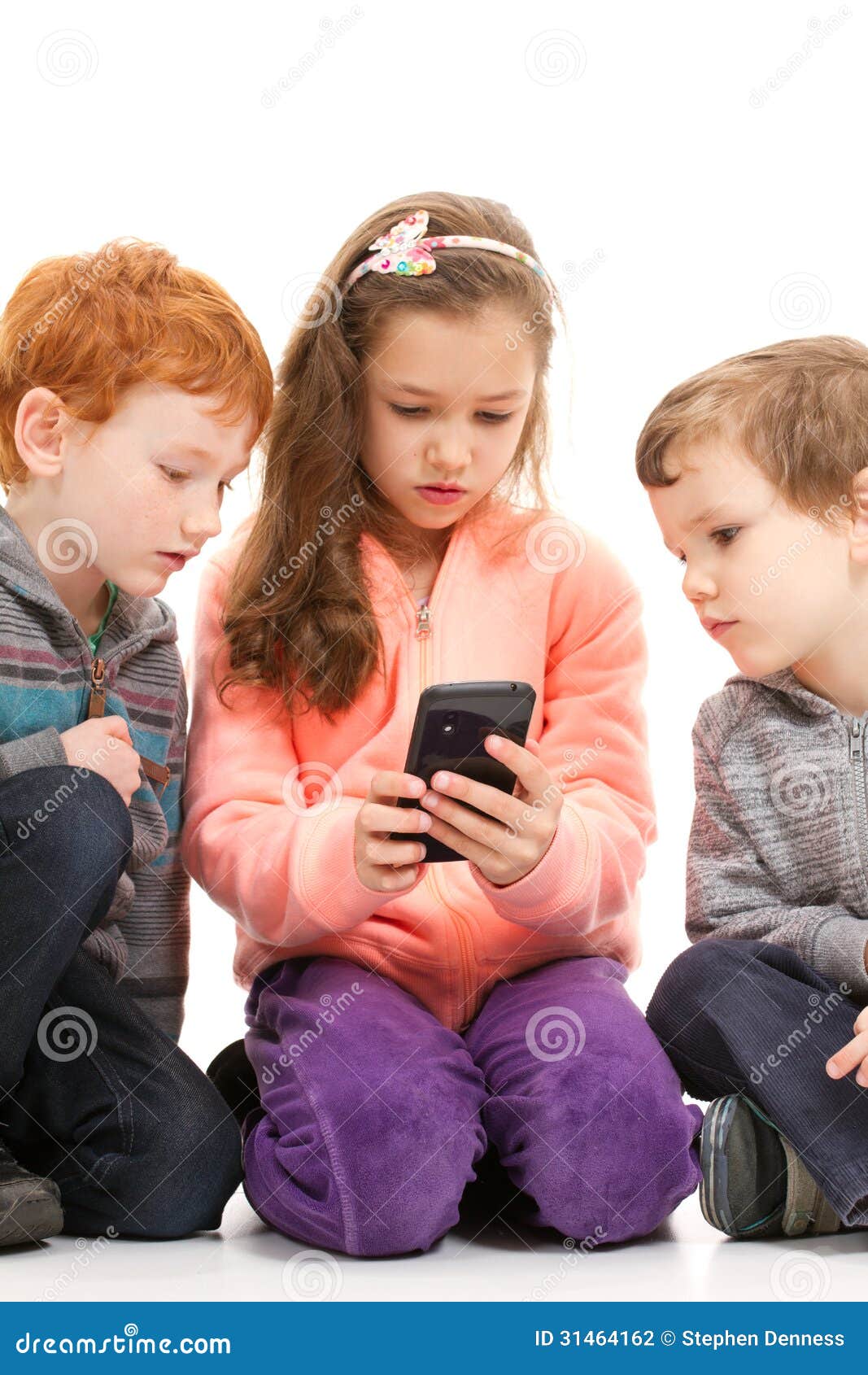 Kids looking at smartphone stock photo. Image of communication - 31464162