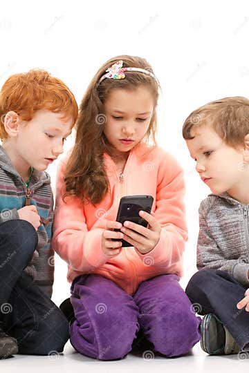 Kids looking at smartphone stock photo. Image of communication - 31464162