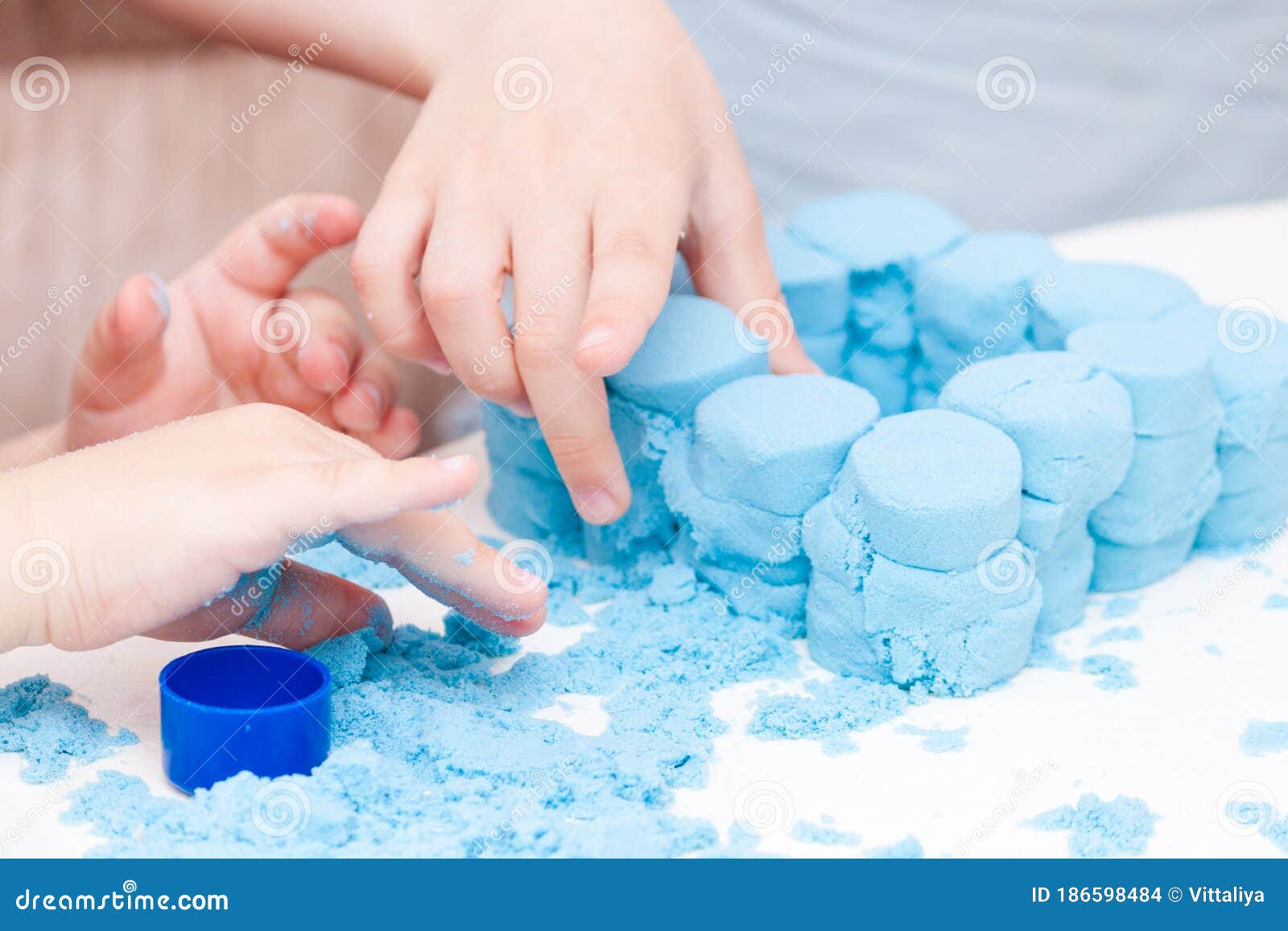 Kids Making Figures from Blue Kinetic Sand Stock Photo - Image of ...