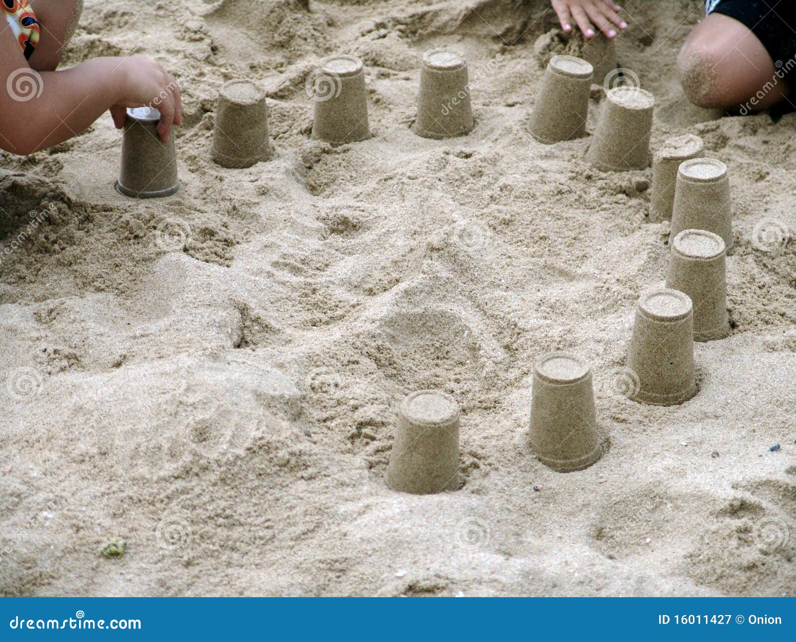 Kids making sand cups stock image. Image of playful, young - 16011427