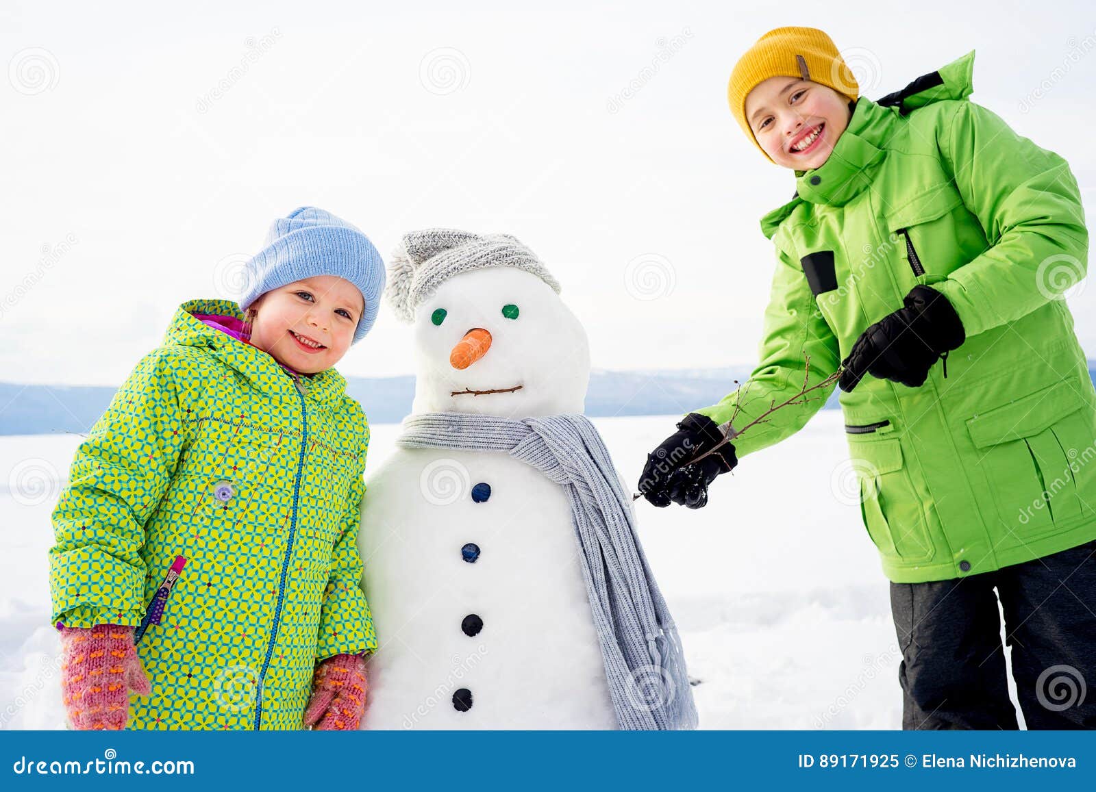 Kids making a snowman stock image. Image of frozen, mother - 89171925