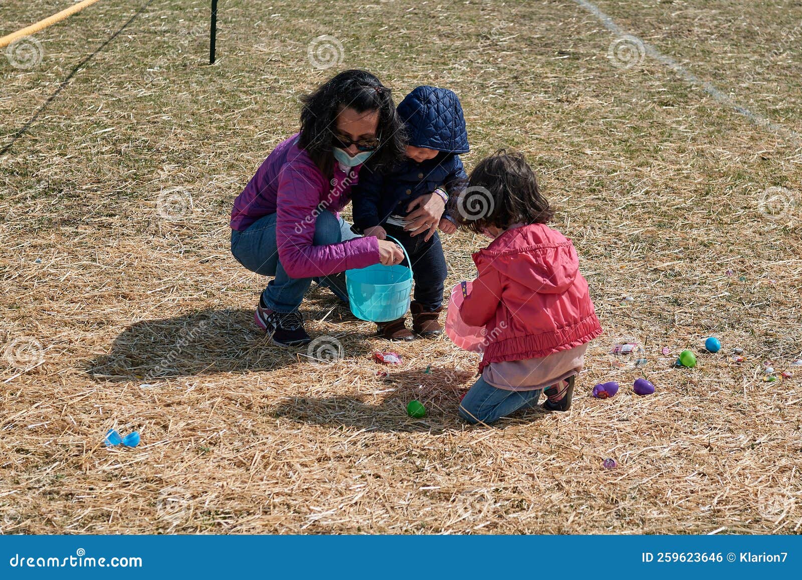 Kids with Mom are Searching for Easter Eggs during an Egg Hunt Stock ...