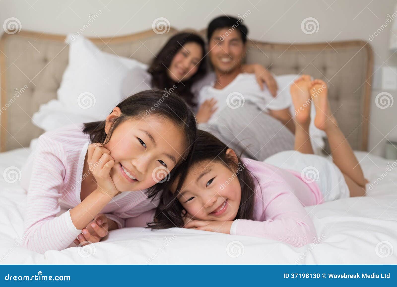 Kids with Parents in Bed at Home Stock Photo - Image of closeup, black ...