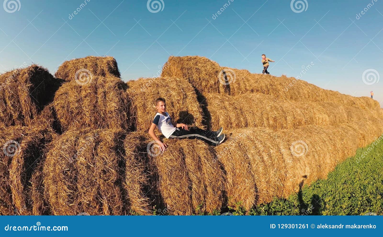 Kids Play in a Stack of Straw. Stock Video - Video of love, farm: 129301261