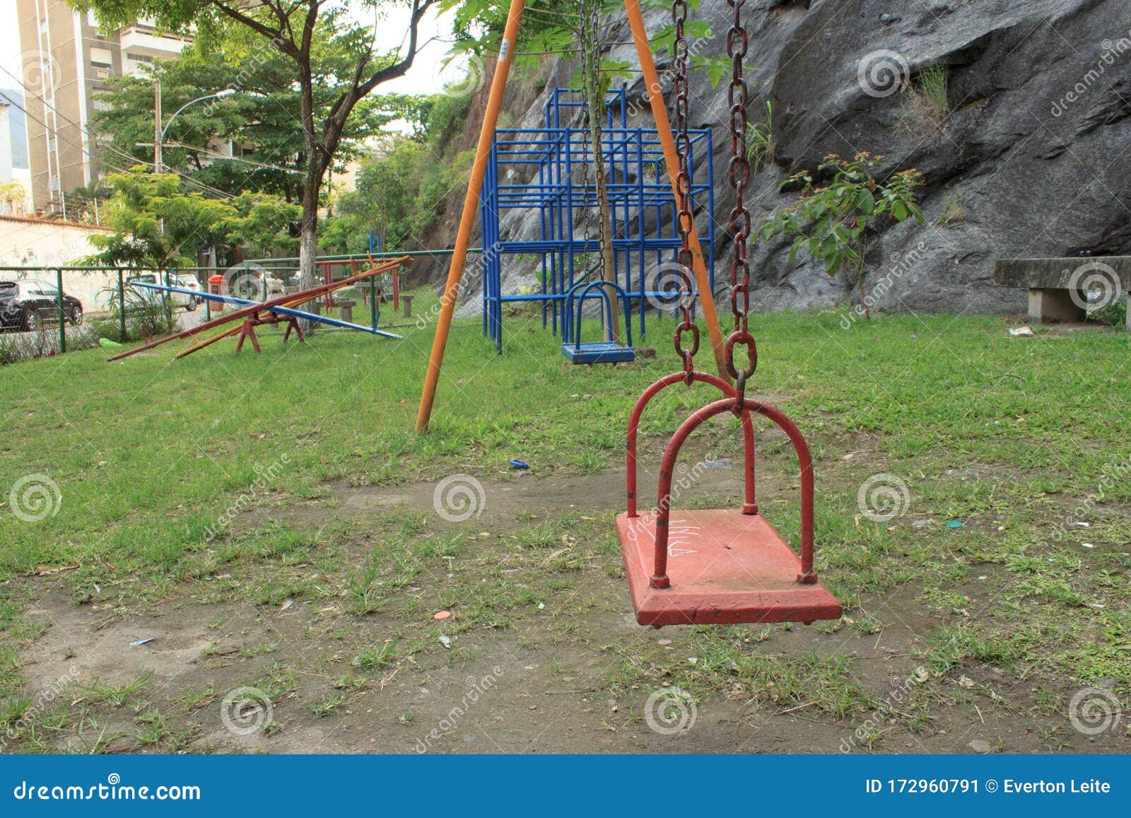 A Kids Playground on a Park Right Next To a Rock Wall Stock Image ...