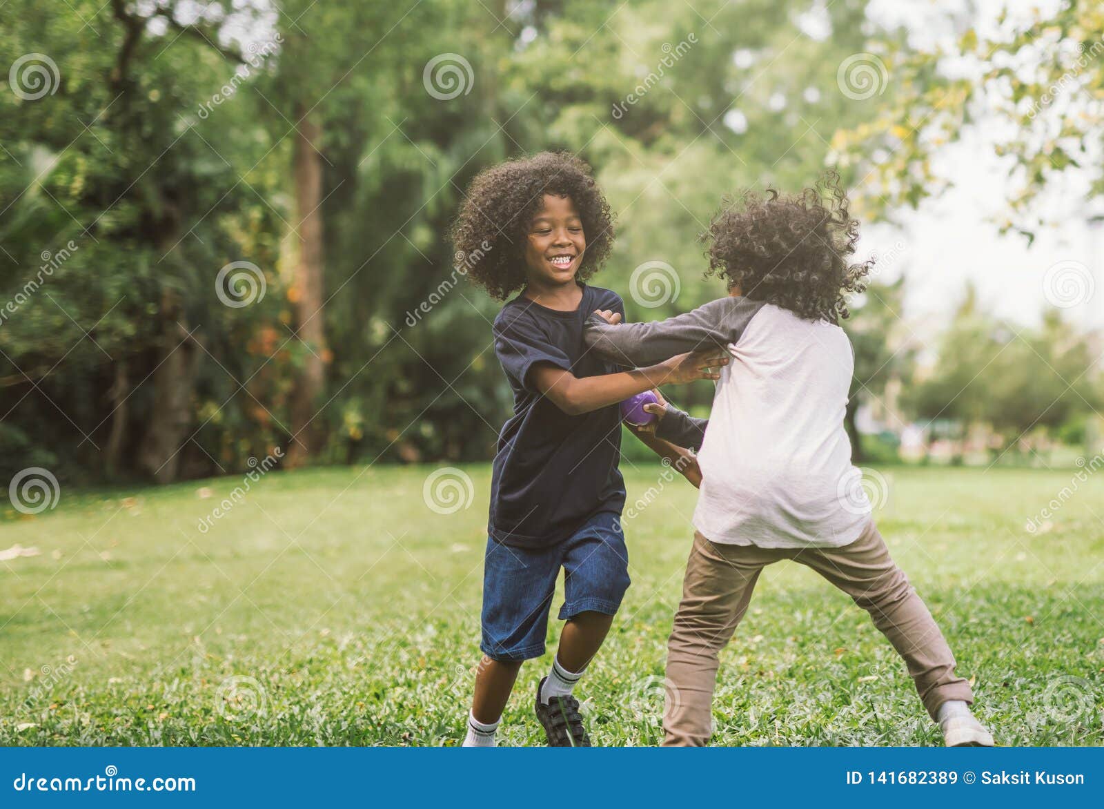 Kids playing with friends. stock image. Image of nature - 141682389