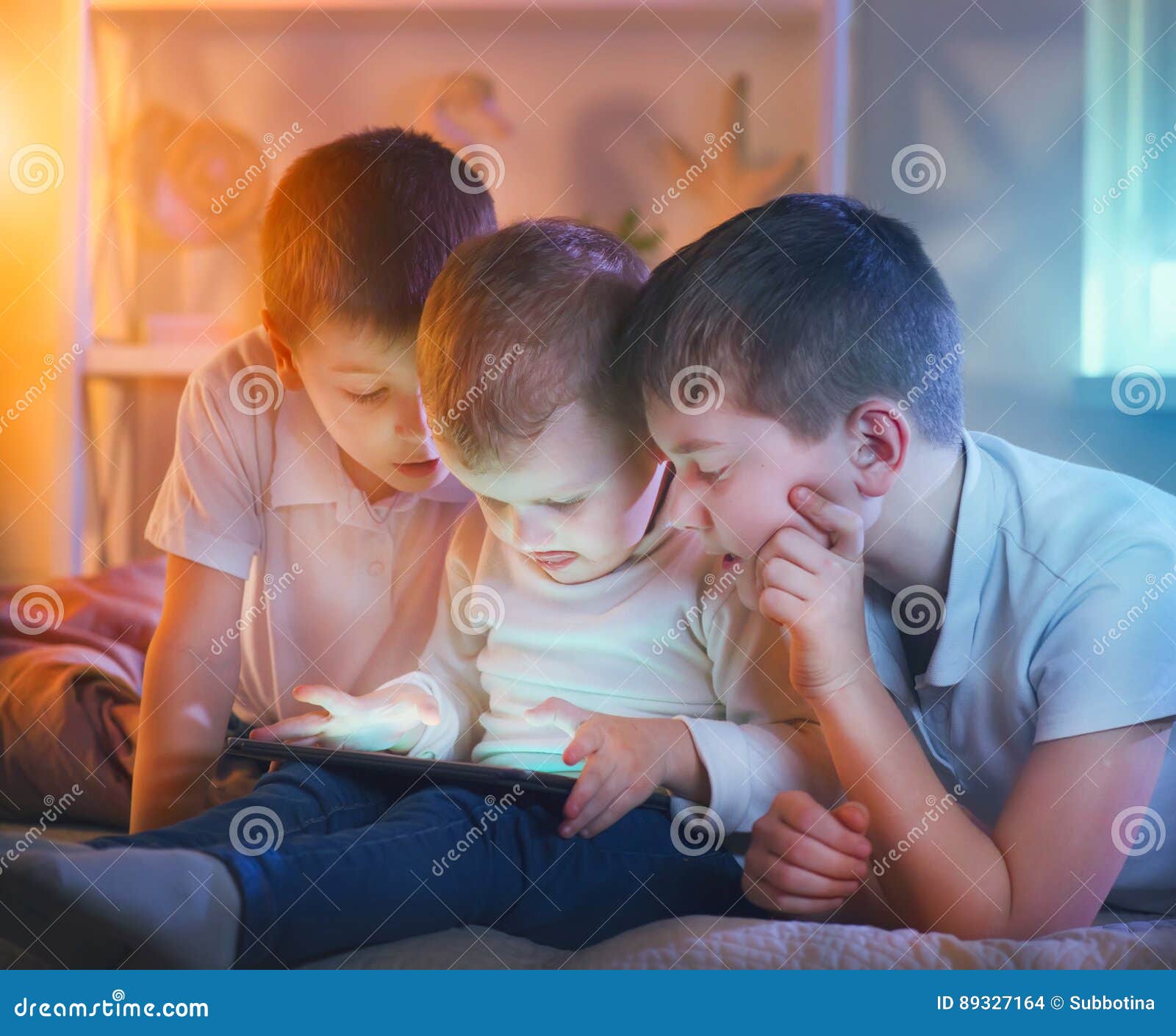 Kids Playing Games on Tablet Pc. Three Little Boys with Tablet Computer ...