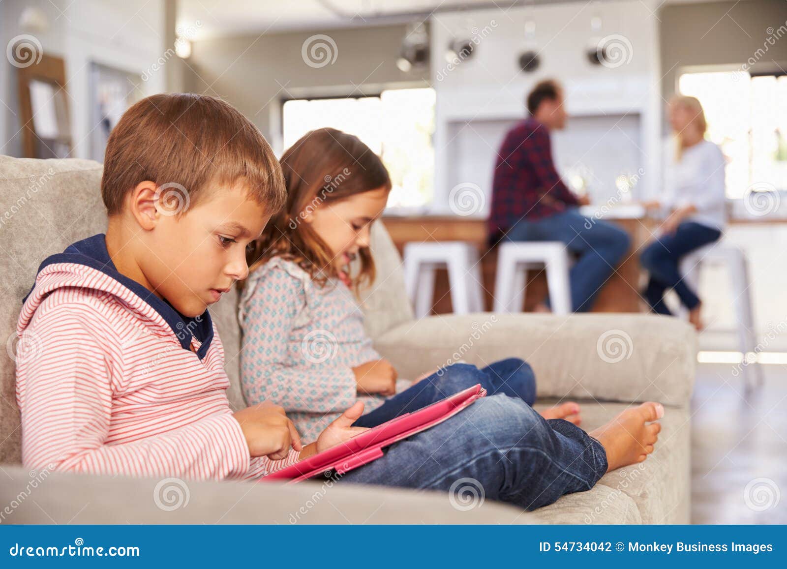 Kids Playing with New Technology while Adults Entertain Stock Photo ...