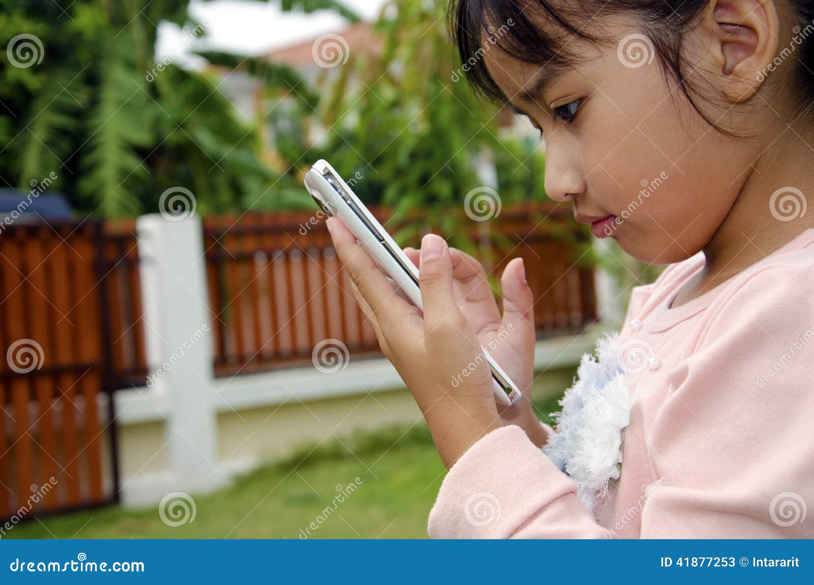 Kids playing phone stock image. Image of girly, cell - 41877253