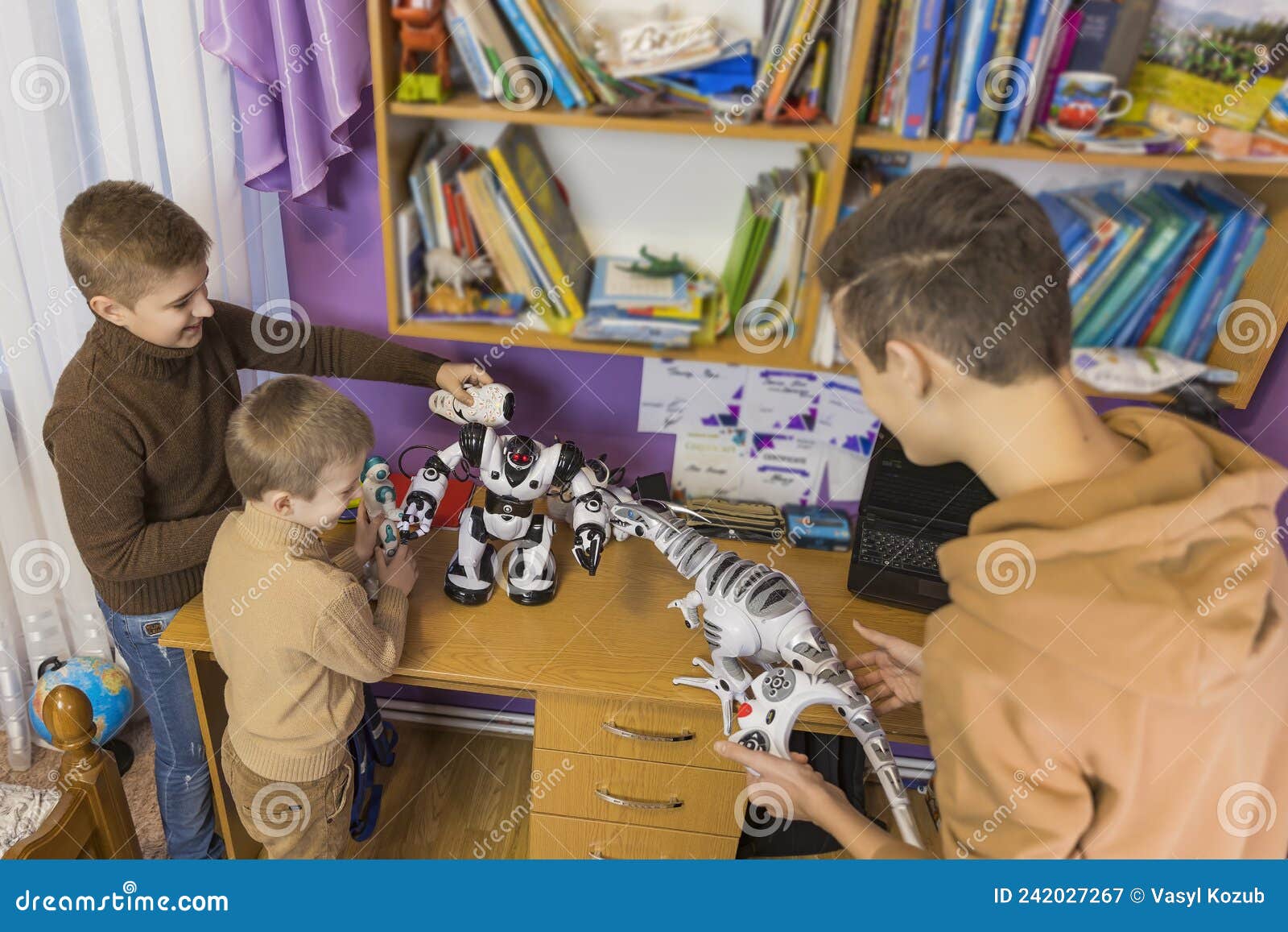 Kids playing with robots stock image. Image of caucasian - 242027267