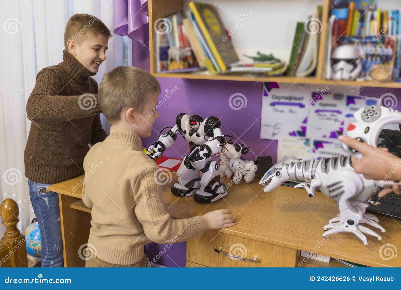Kids playing with robots stock photo. Image of development - 242426626