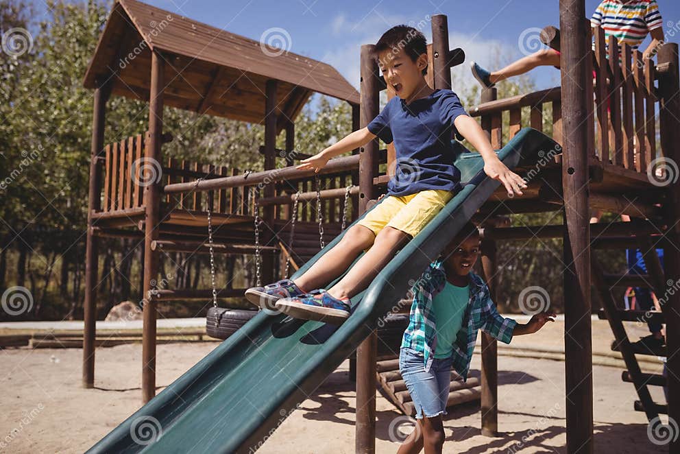 Kids playing on slide stock photo. Image of chinese, casual - 93213672
