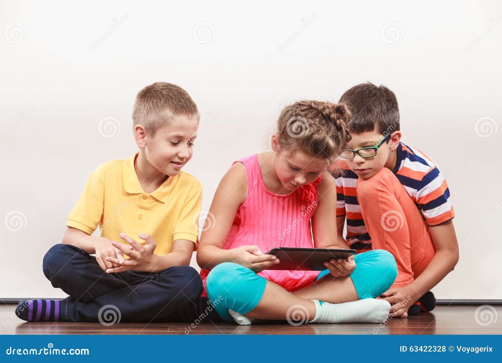 Kids playing on tablet. stock photo. Image of technology - 63422328