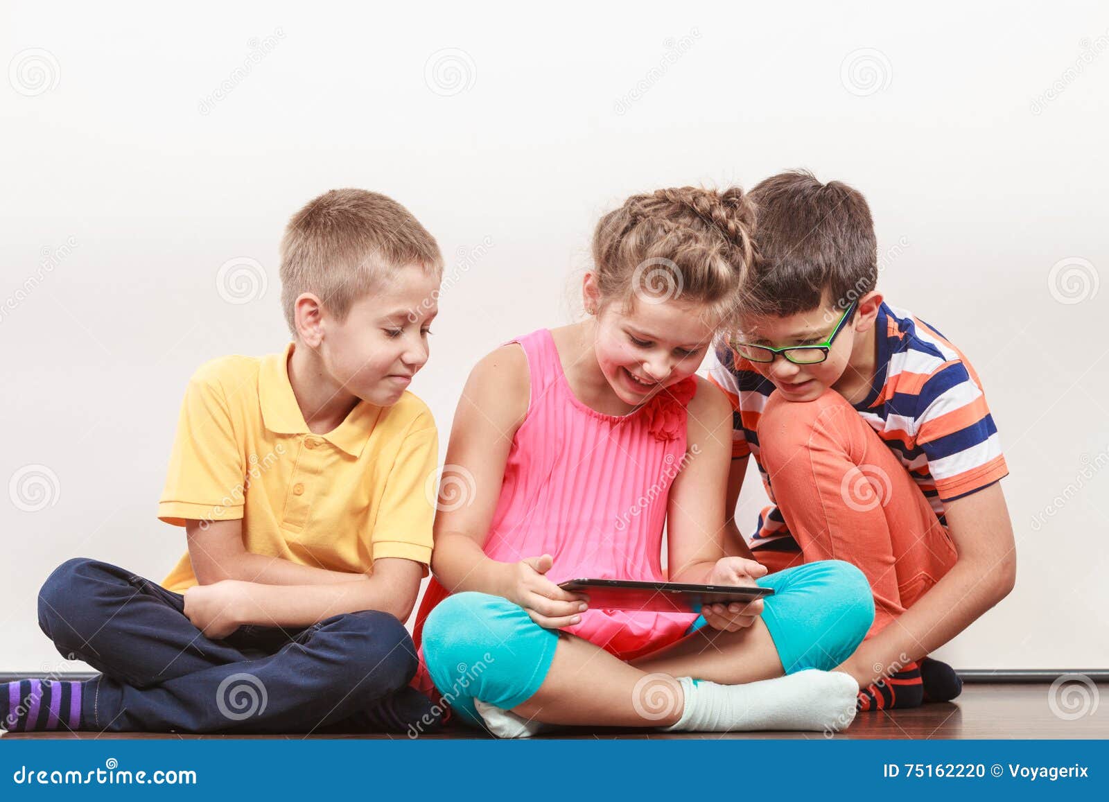Kids playing on tablet. stock photo. Image of elementary - 75162220