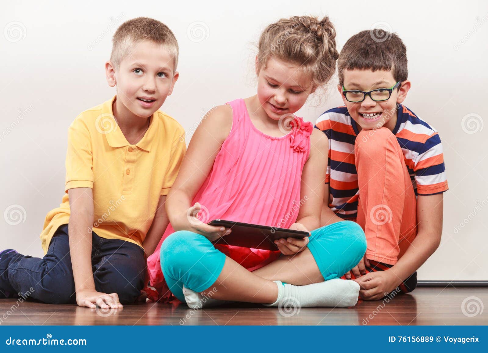 Kids playing on tablet. stock image. Image of friendship - 76156889