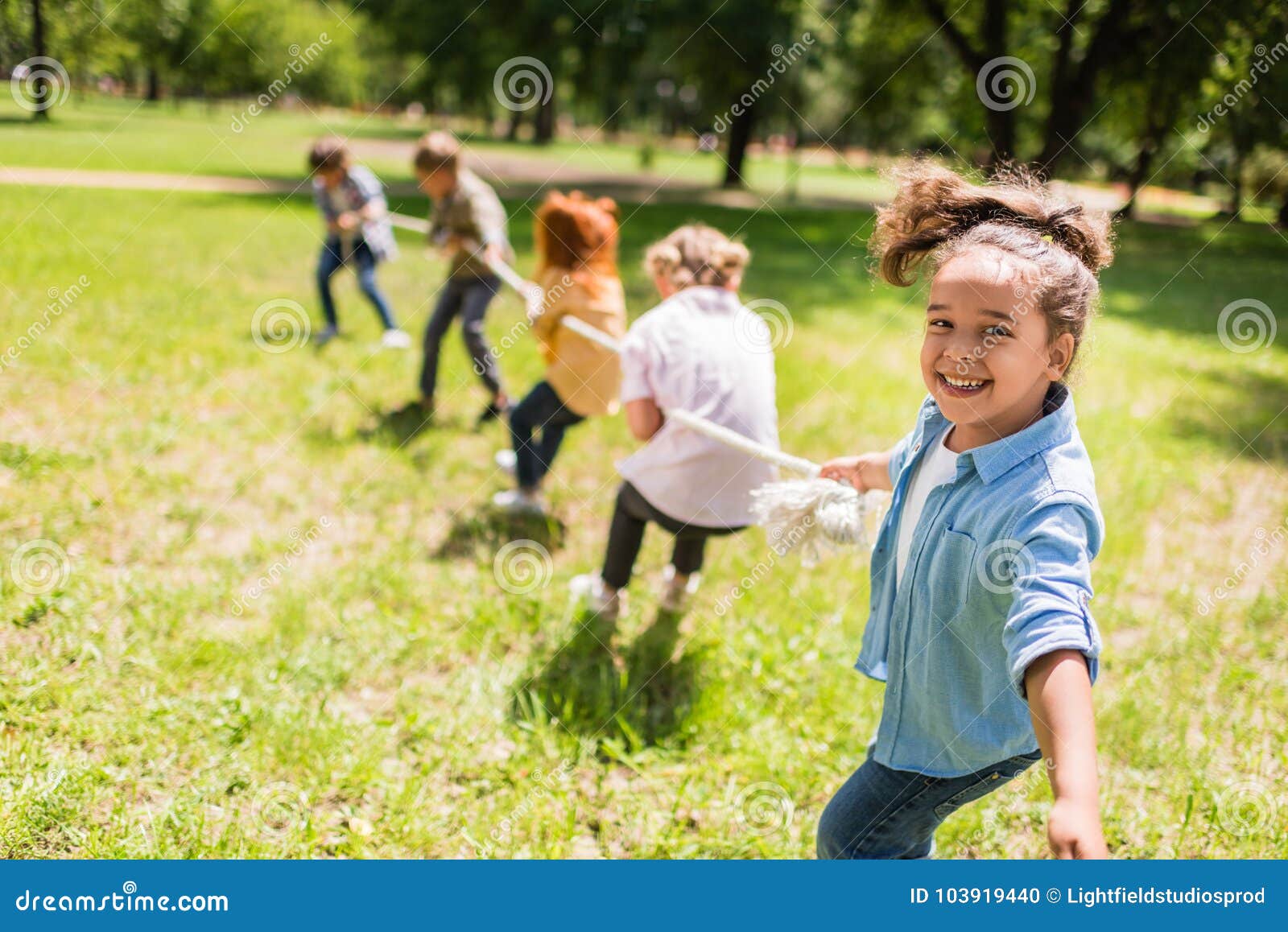 Kids playing tug of war stock photo. Image of boyhood - 103919440