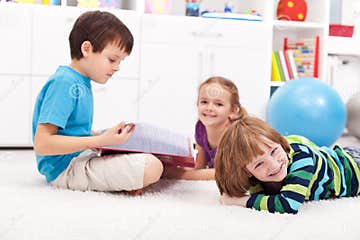 Kids Reading a Book and Having Fun Stock Photo - Image of room, floor ...