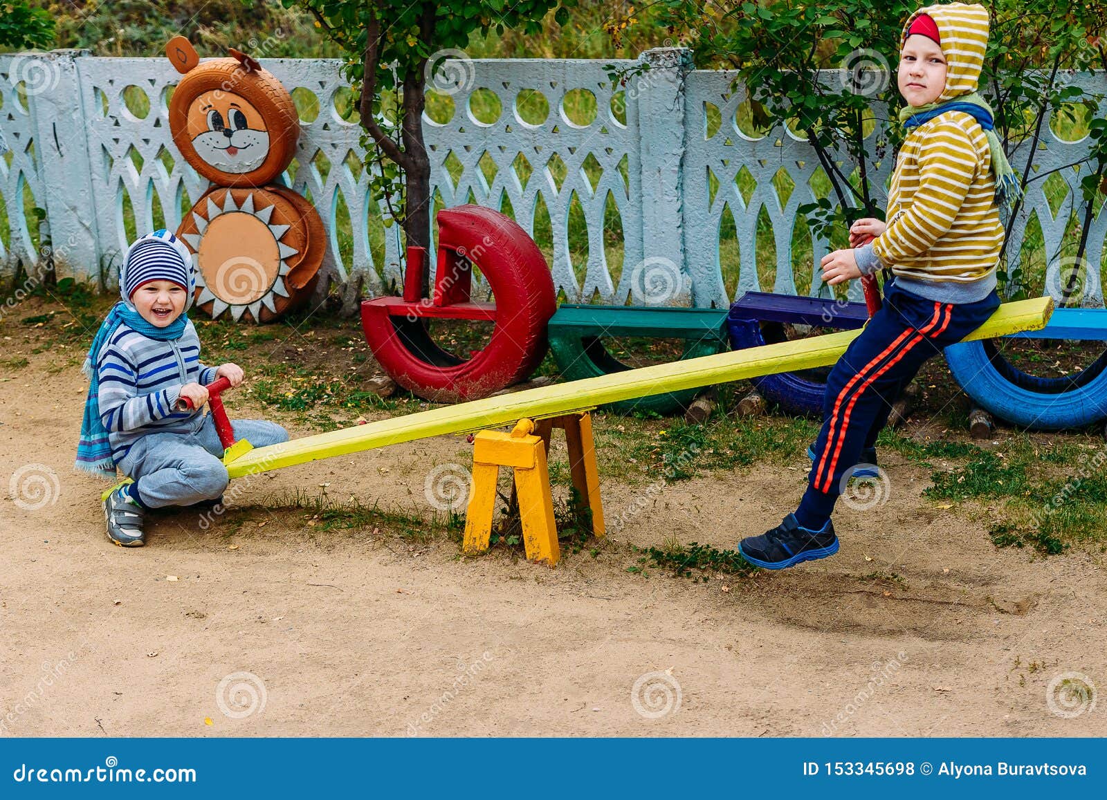 Kids Ride a Swing in the Playground Stock Photo - Image of active ...