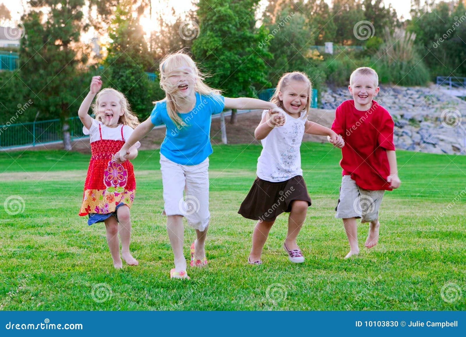 Kids running on the grass stock photo. Image of smiling - 10103830