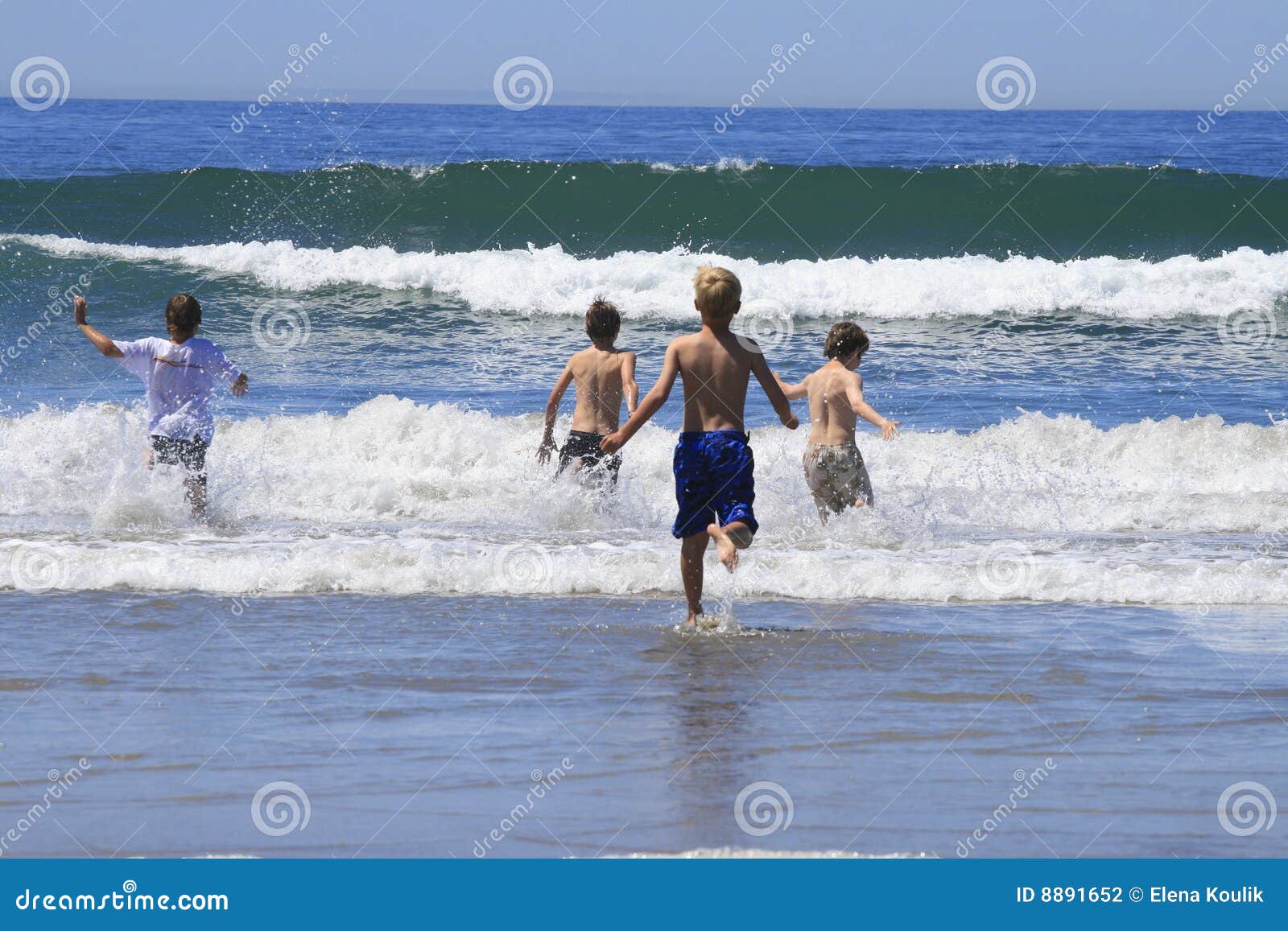 Kids running into waves stock photo. Image of excitement - 8891652